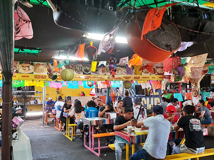 Colorful chaos in the best possible way – this food court's vibrant decor matches the bold flavors coming from every direction.