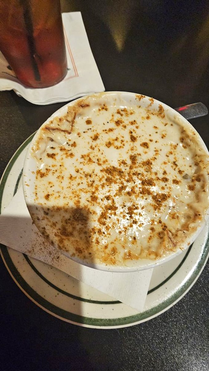 The French onion soup arrives with a golden crown of bubbling cheese that stretches dramatically with each spoonful—comfort in a crock.