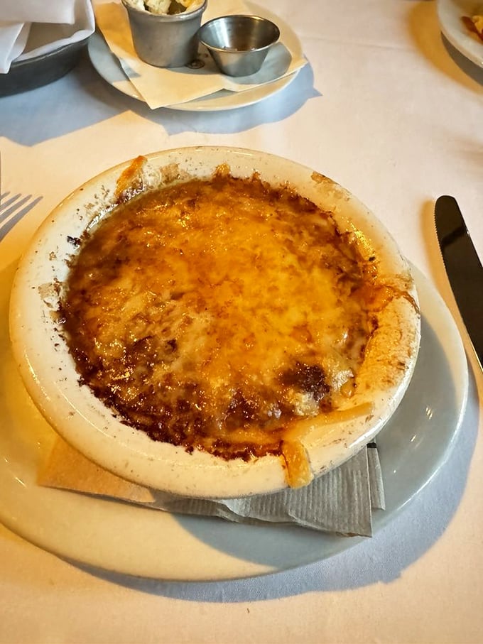 French onion soup so authentic it needs a passport—that golden cheese cap conceals a savory broth worth diving into headfirst.