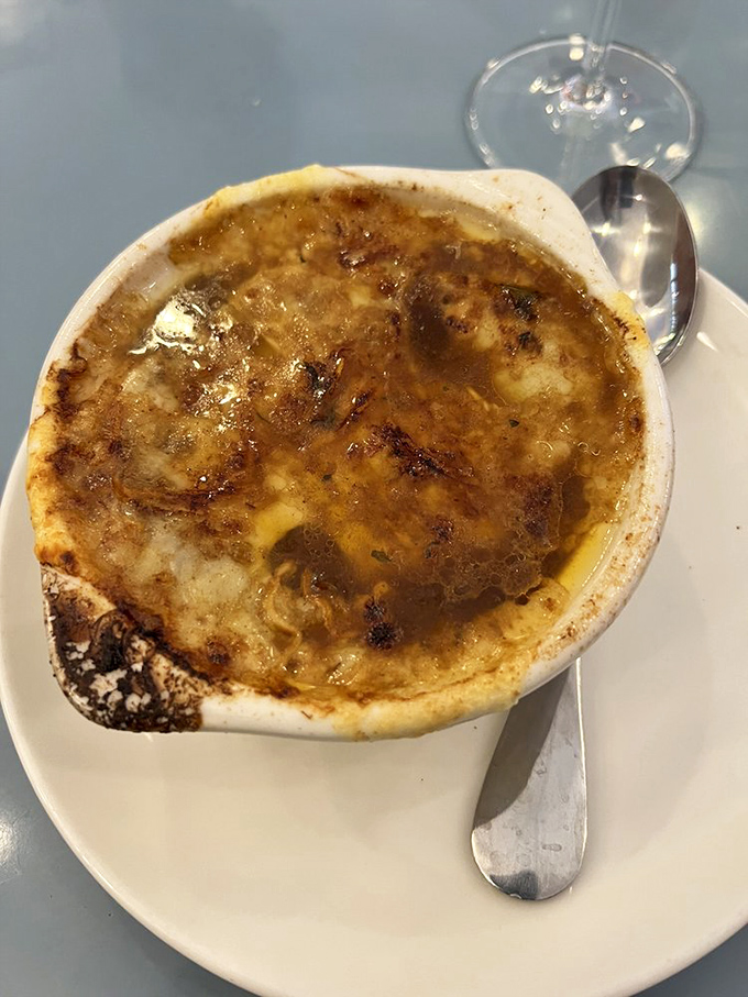 French onion soup that's achieved the impossible trifecta: perfectly caramelized onions, rich broth, and that glorious crown of broiled cheese.
