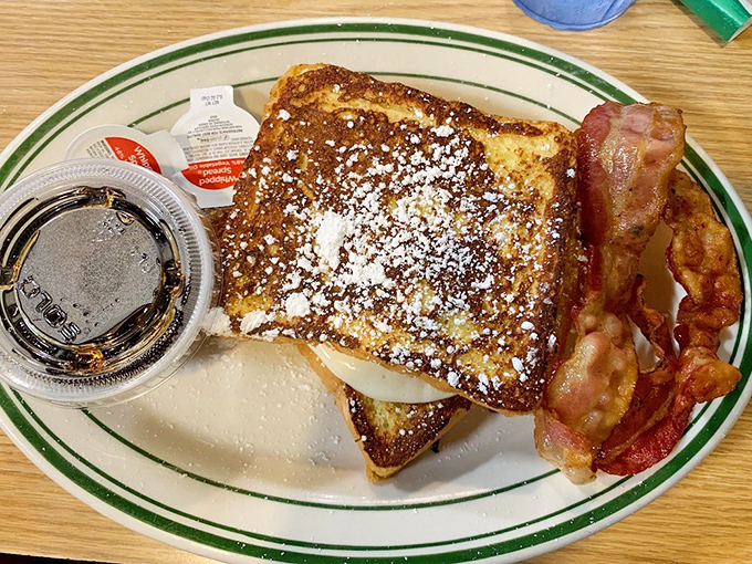 French toast that's dressed for success with a dusting of powdered sugar and bacon sidekicks. Breakfast royalty that doesn't need a fancy crown.