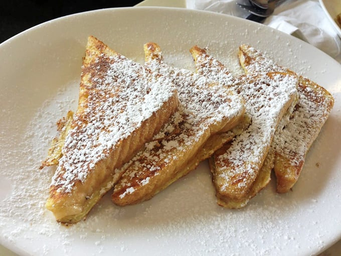 French toast that's achieved celebrity status – powdered sugar dusted triangles that make you wonder if dessert for breakfast is actually the smartest idea ever.