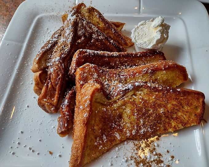 This isn't just French toast—it's a golden-brown masterpiece dusted with powdered sugar that transforms ordinary bread into breakfast royalty.