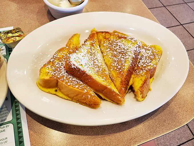 French toast that's dressed for success – golden, fluffy, and dusted with powdered sugar like the first snow of winter.