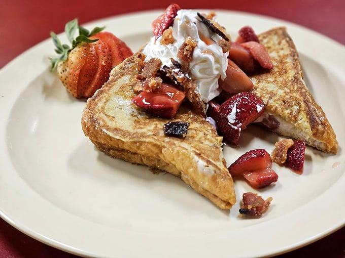 French toast that doesn't need a passport to impress—crowned with fresh strawberries and whipped cream, it's breakfast royalty in disguise.