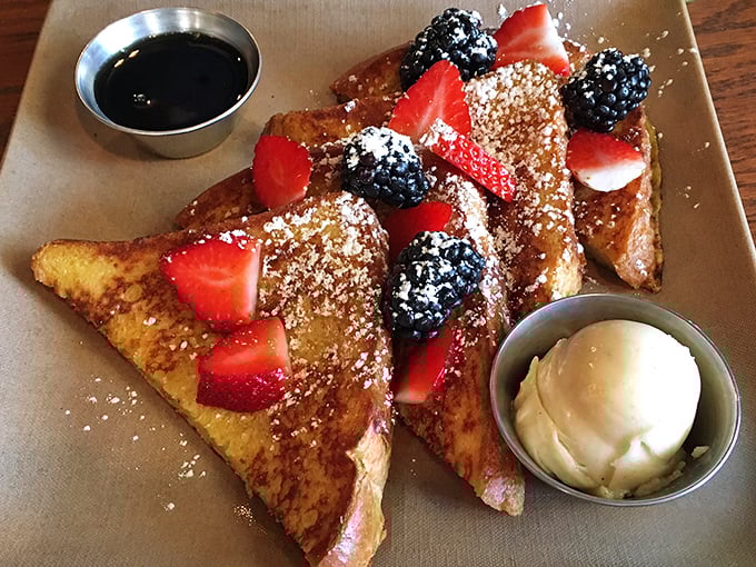 French toast that's crossed the line from breakfast to dessert, with berries and cream playing supporting roles in this morning theater of deliciousness.