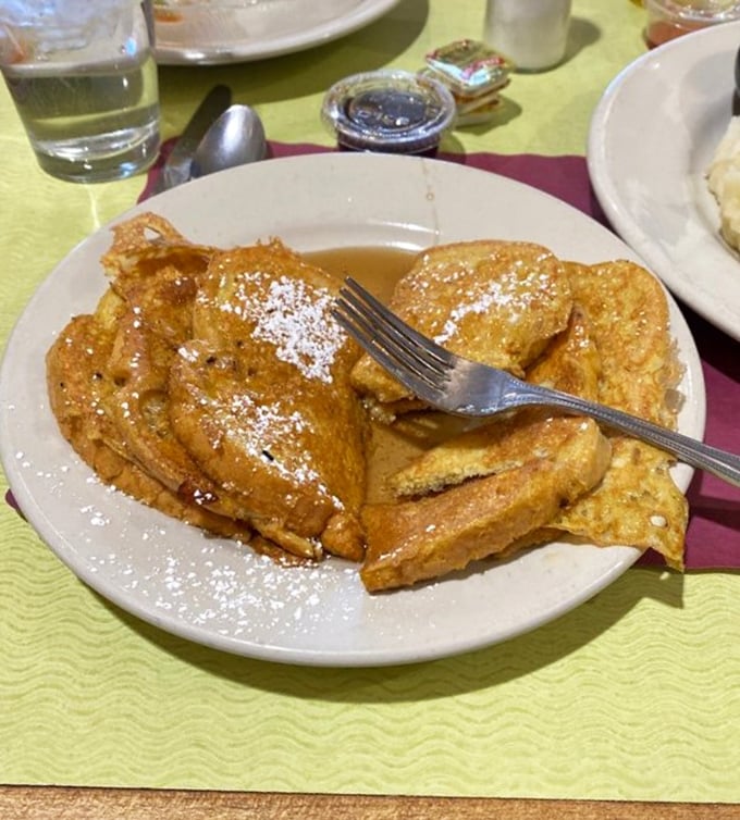 French toast that would make your bubbe weep with joy – golden, crispy edges giving way to a custardy center that puts brunch spots to shame.