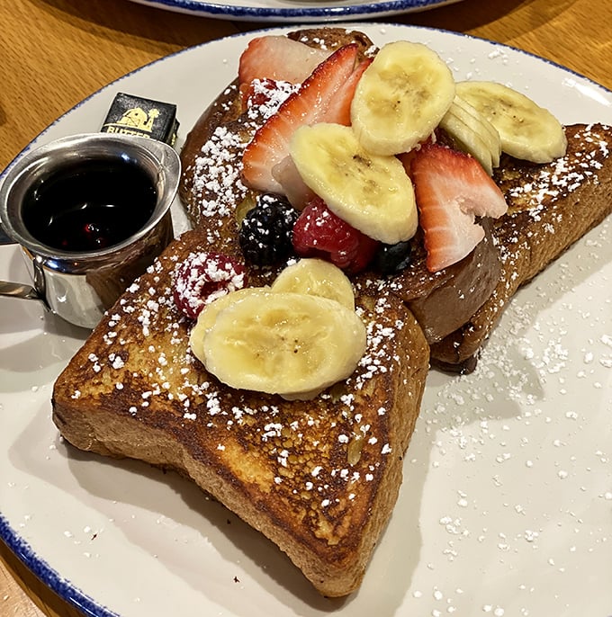 French toast that doesn't just arrive – it makes an entrance. Fruit, powdered sugar, and maple syrup create breakfast's answer to formal evening wear.