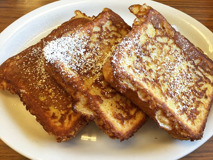 French toast that would make a Parisian jealous. Three slices of golden perfection dusted with powdered sugar—no passport required.