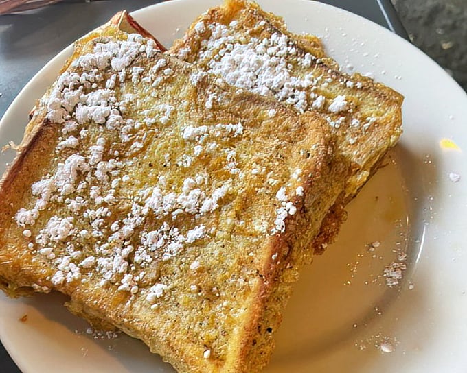 French toast that's dressed for success – powdered sugar snow atop golden bread islands floating in a maple syrup sea.