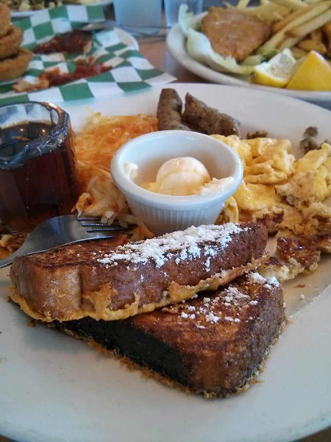 French toast that dreams are made of—dusted with powdered sugar and served with all the breakfast fixings.