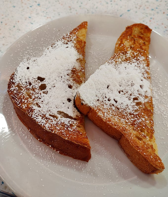 Golden French toast dusted with powdered sugar snow – breakfast masquerading as dessert, and nobody's complaining.
