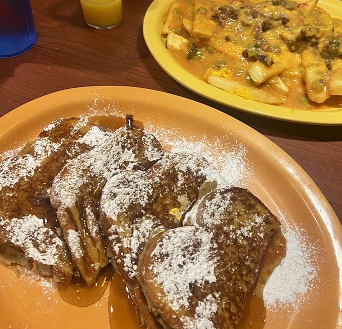 French toast dusted with powdered sugar and drizzled with syrup—proof that sometimes the simplest pleasures are the most profound.