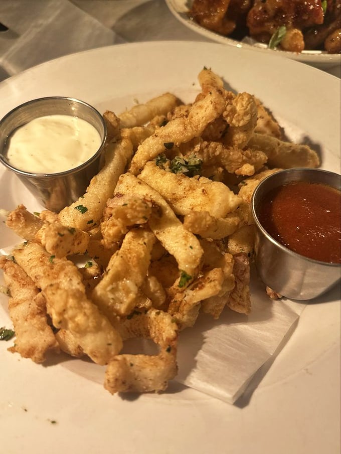 Calamari so perfectly fried it makes you wonder why other restaurants even try – crisp, tender, and served with dipping sauces that demand to be explored.