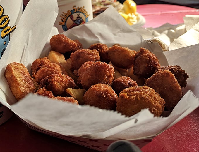 Golden-fried morsels nestled in paper – each bite delivering that perfect crunch before yielding to tender seafood within. Worth every napkin.