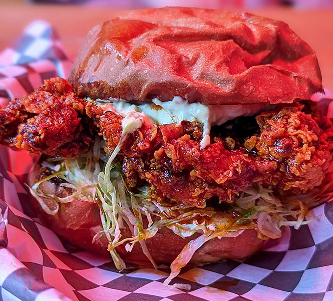 The fried chicken sandwich that launched a thousand cravings—a crimson-hued masterpiece where crunch meets tenderness in perfect harmony.