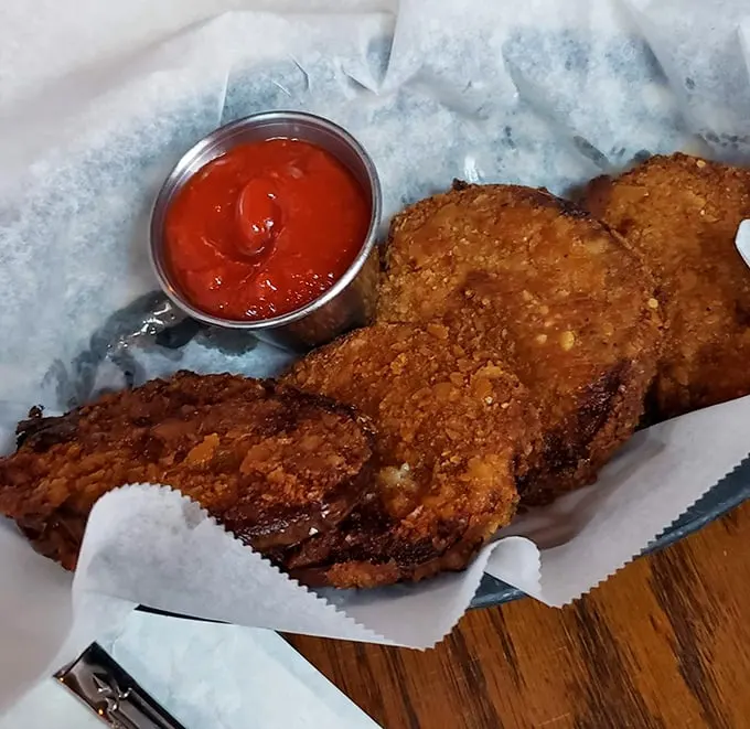 Golden-fried perfection with a side of tangy sauce – these crispy discs are what happens when comfort food gets dressed up for a night out.