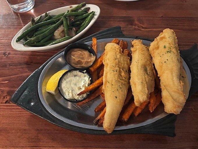 Lake Erie perch fried to golden perfection with sweet potato fries and homemade tartar sauce—proof that sometimes the best seafood isn't from the ocean.