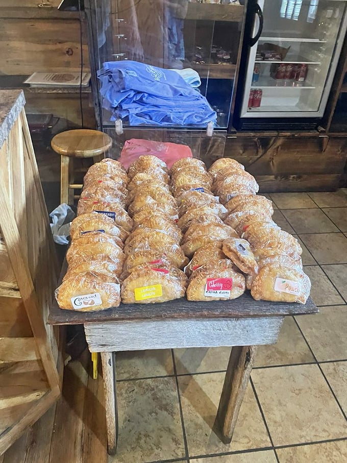 The fried pie display—where fruit-filled pastry pouches wait patiently to fulfill their destiny as the perfect handheld dessert or breakfast. No judgment here.