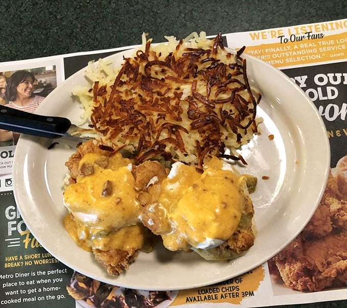 Crispy fried chicken perched atop hash browns, smothered in cheese. Breakfast architecture at its most deliciously dangerous.