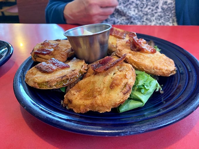 Fried green tomatoes – crispy, golden discs of Southern tradition topped with bacon. Proof that unripe fruit can indeed be the star of the show.