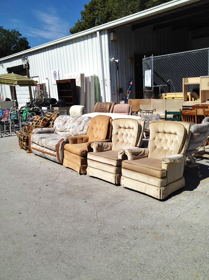 The furniture graveyard—where yesterday's living room centerpieces await resurrection in your home at a fraction of their original cost.