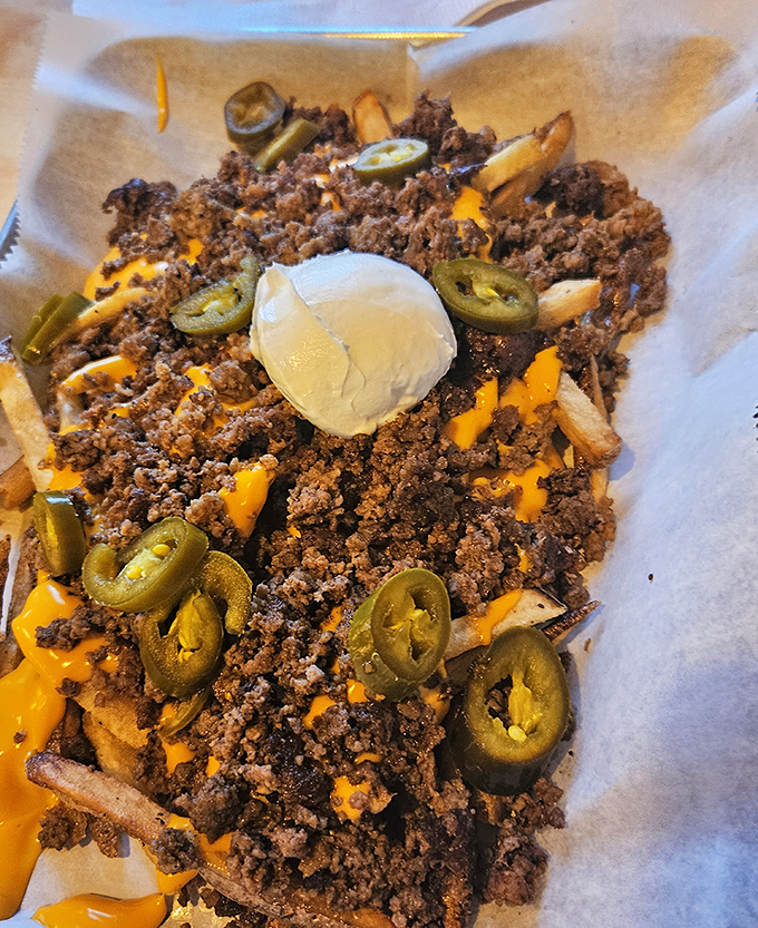 Ghetto Fries: where ground beef, molten cheese, jalapeños and a dollop of sour cream transform humble potatoes into a dish worth fighting over.