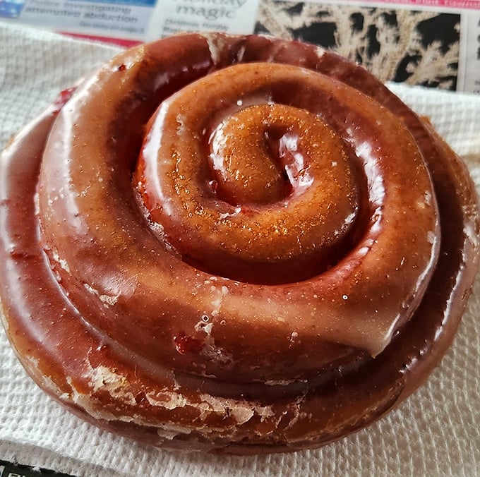 This cinnamon roll isn't just glazed—it's practically lacquered with sweetness, each spiral promising a journey deeper into flavor.