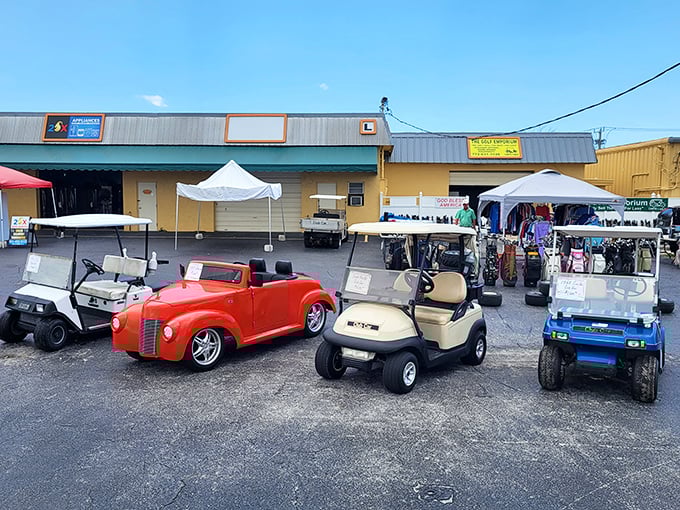 Not your ordinary parking lot! A cherry-red vintage roadster sits among golf carts, proving even the transportation at B&A has character and stories to tell.