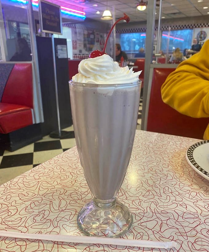 That's not just a milkshake—it's a tower of creamy nostalgia topped with whipped cream and a cherry that's begging to be Instagrammed before it's devoured.
