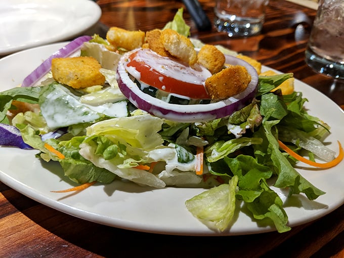 A salad that actually deserves respect—crisp, colorful, and crowned with those perfect red onion rings that make you forget you're eating vegetables.