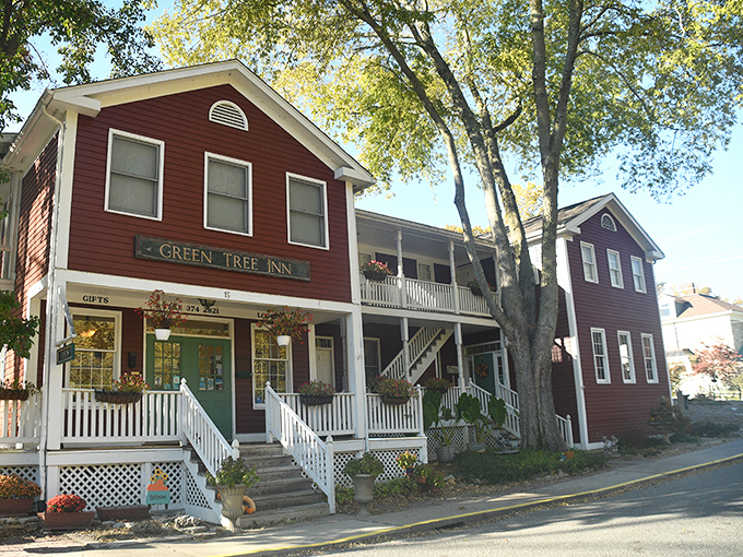 The Green Tree Inn stands proudly in its crimson glory, offering weary travelers what chain hotels can't—authentic character and homemade breakfast.