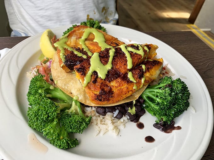 Blackened barramundi that's having its glamour shot moment. That vibrant green sauce isn't just pretty—it's the perfect tangy counterpoint.