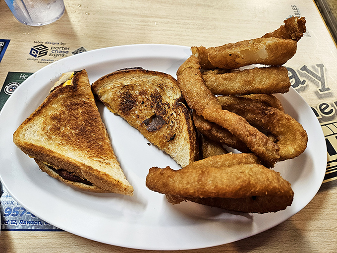 Golden-brown toast hugging melted cheese with crispy onion rings standing guard—a lunch combo that speaks the universal language of comfort.