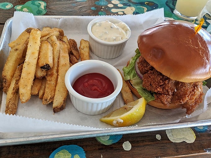 A grouper sandwich that requires a game plan before the first bite. Those fries aren't sides – they're co-stars in this Florida production.