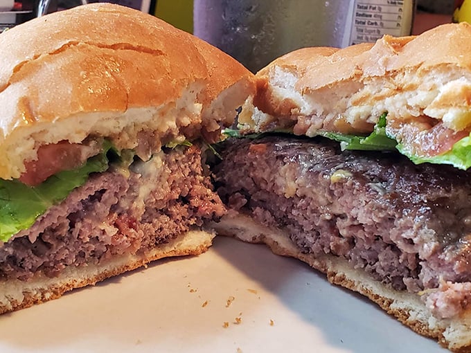A burger cut in half reveals the truth—this isn't some fast-food imposter. It's the real deal, juicy and substantial, like a handshake from an old friend.