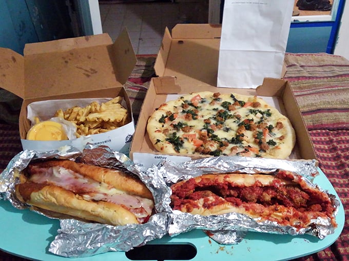 A feast fit for sharing (or not) – hoagies, pizza, and fries creating the kind of spread that turns strangers into friends.