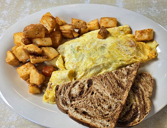 Breakfast perfection doesn't need fancy names—just perfectly crispy home fries, eggs with sunshine-yellow yolks, and toast waiting for its butter bath.