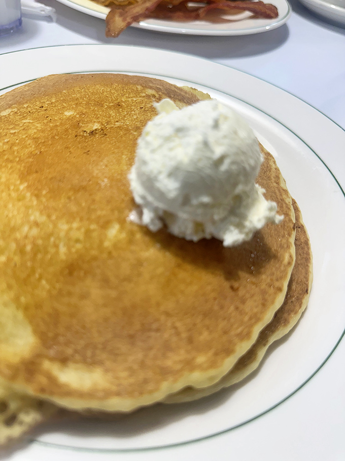 Pancakes so golden they could qualify for Olympic medals, topped with a snowball of butter melting into a warm breakfast pond. 