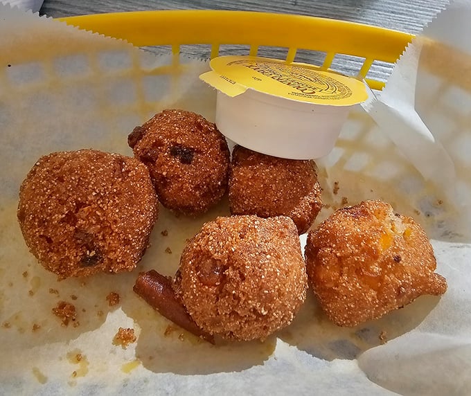 Golden-brown hush puppies that would make your Southern grandmother weep with joy. Crispy exterior, tender inside – the perfect seafood sidekick.