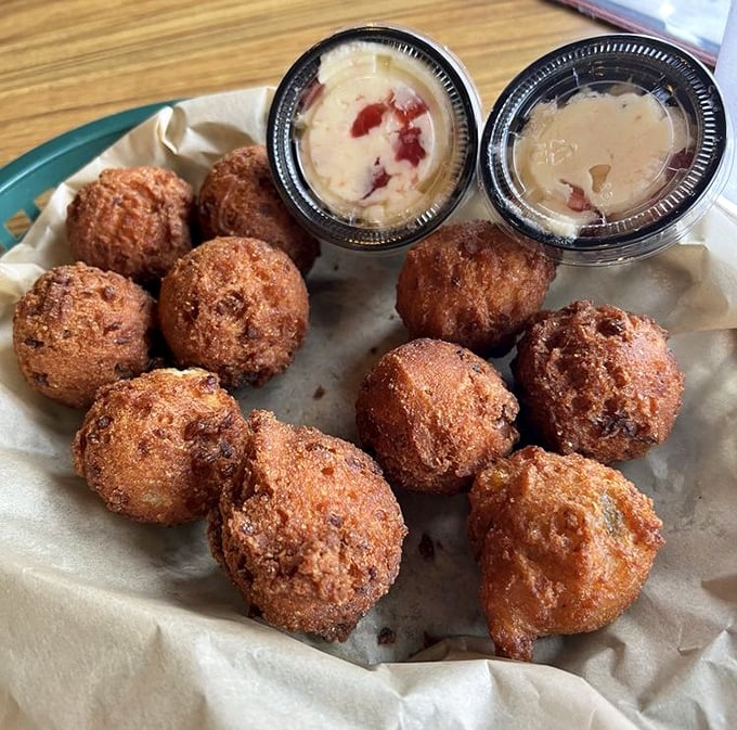 These aren't your average hush puppies. Golden-fried perfection with a tender interior, served with dipping sauces that'll make you forget your manners.