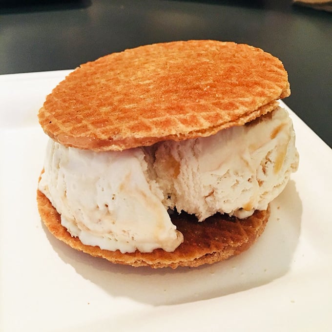 The humble ice cream sandwich reimagined—golden waffle discs embracing a generous scoop of creamy vanilla perfection.
