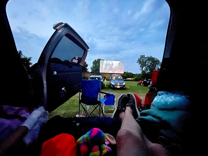 The roadside marquee promises entertainment under the stars. Cars queue up for that perfect combination of movies, snacks, and Wisconsin summer nights.