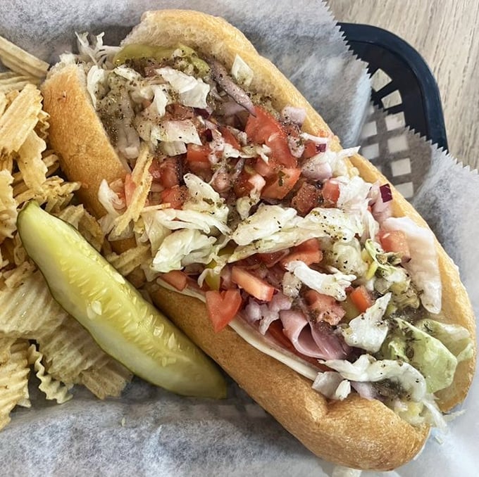 The Italian hoagie arrives like edible architecture—a cathedral of cold cuts, fresh vegetables, and seasonings that would make nonna weep with joy.