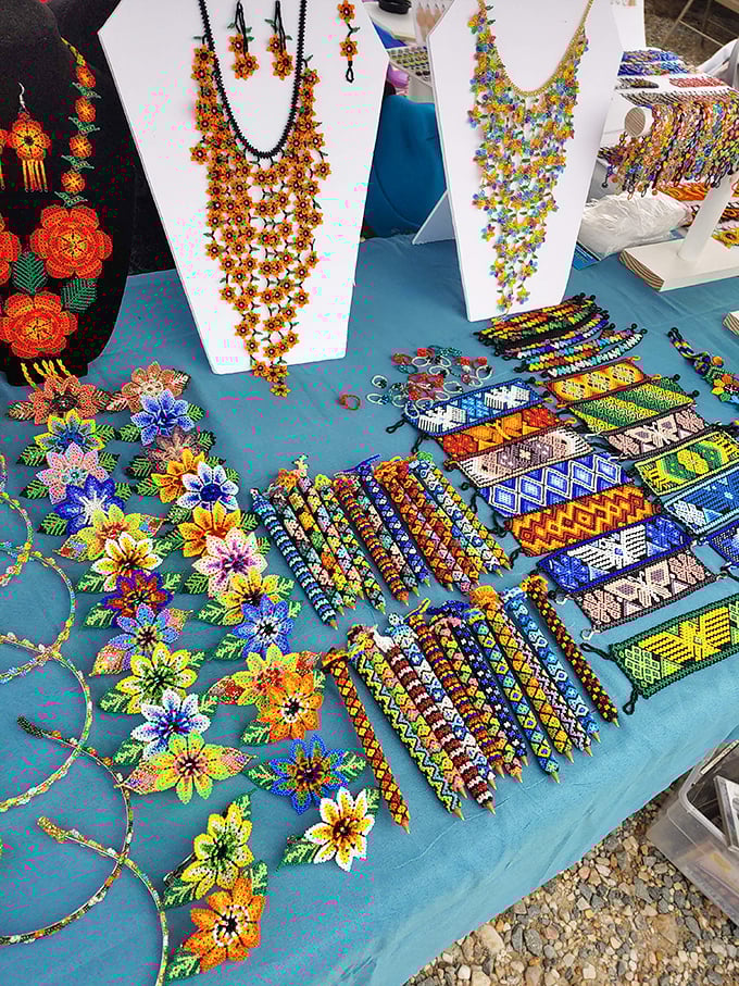 Beaded masterpieces that would make Frida Kahlo swoon—intricate handcrafted jewelry transforms a simple blue tablecloth into an artist's canvas.