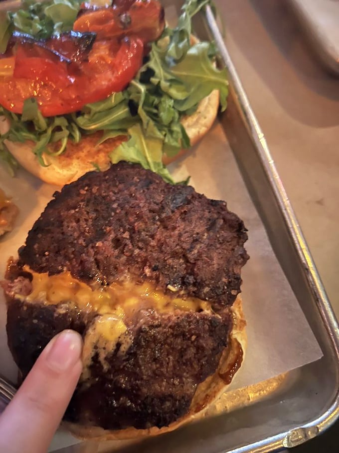 Behold the burger of your dreams—a perfectly charred patty oozing with melted cheese that whispers, "Diet? What diet?"