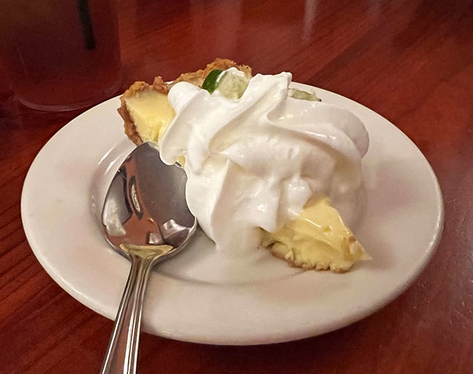 Key lime pie done right—tangy, sweet, and topped with a cloud of whipped cream that makes you forget about beach season entirely.