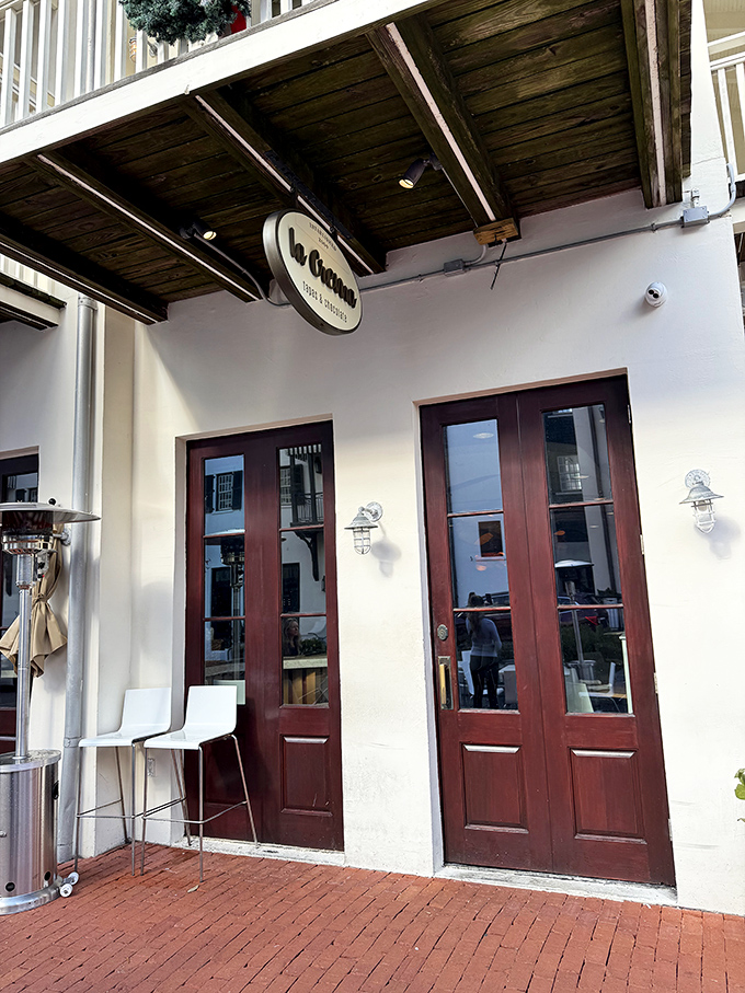 La Crema's inviting entrance promises Spanish-inspired delights within. Those wooden doors might as well be portals to tapas heaven—no passport required.