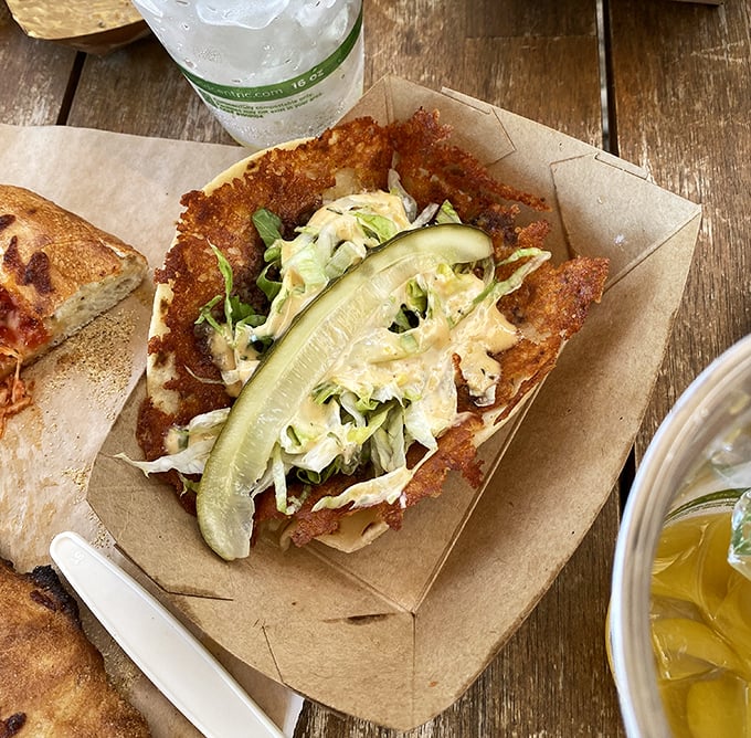 Crispy exterior, tender filling, and a pickle slice that cuts through the richness—this taco doesn't just satisfy hunger, it creates happiness.