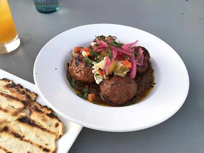 These lamb kofta are flavor bombs—tender, spiced meatballs topped with pickled onions and fresh herbs that would make any Mediterranean grandmother proud.